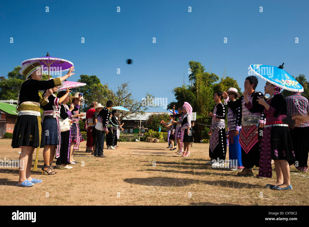 Young people in traditional dress, playing ball, New Year festival ...