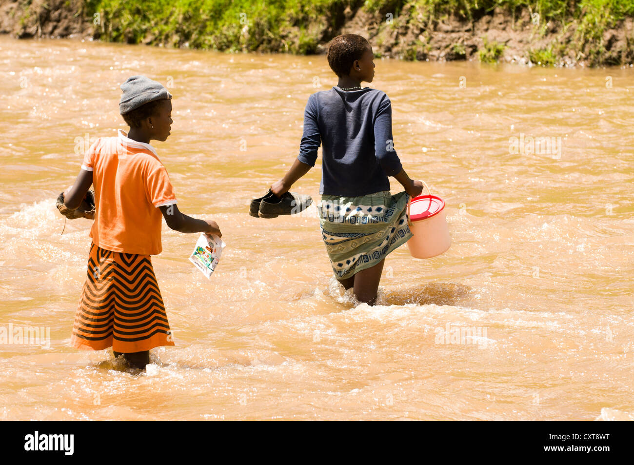 Woman wading through river hi-res stock photography and images - Alamy