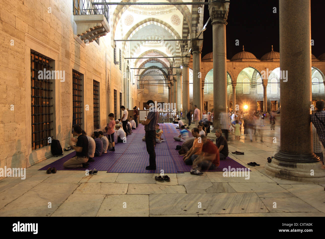Pilgrims gather for the evening prayer at the Blue Mosque in Istanbul ...