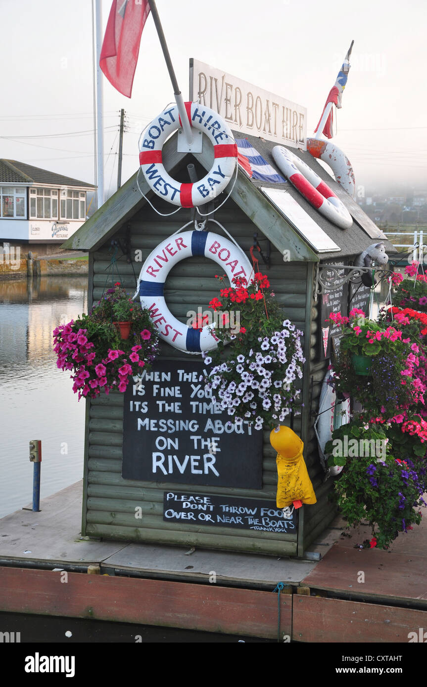 A beautiful kiosk at West Bay, decorated with hanging baskets full of ...