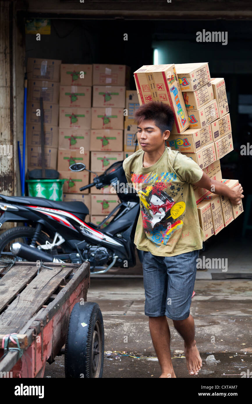 Young Man carrying Boxes in Banjarmasin, Indonesia Stock Photo - Alamy