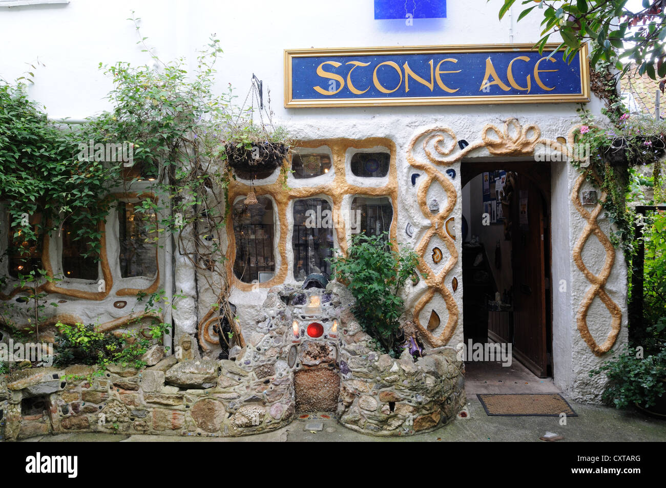 Stone Age shop sign in a courtyard Glastonbury Somerset England UK GB ...