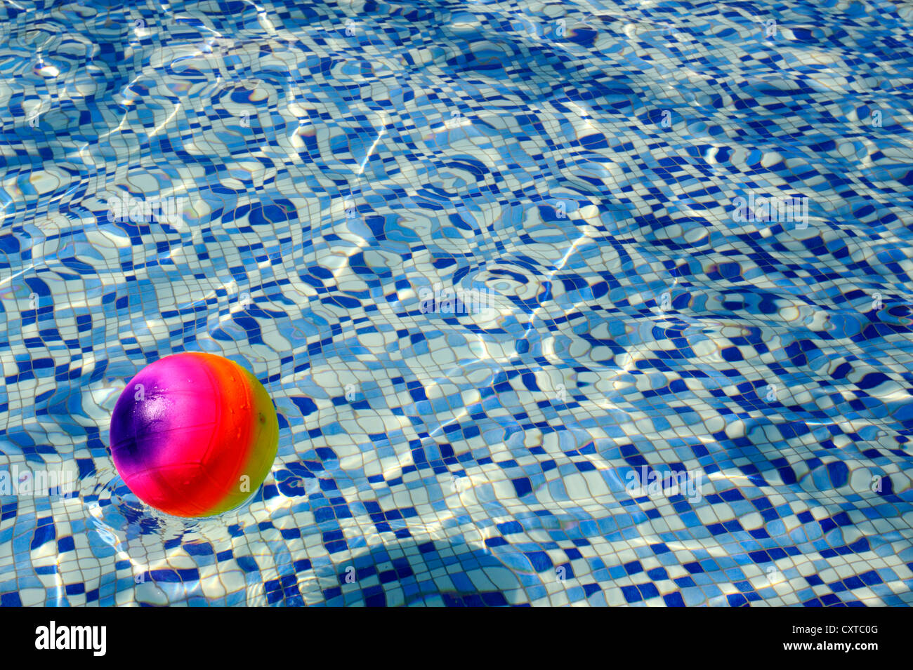 Colourful ball floating on water Stock Photo - Alamy