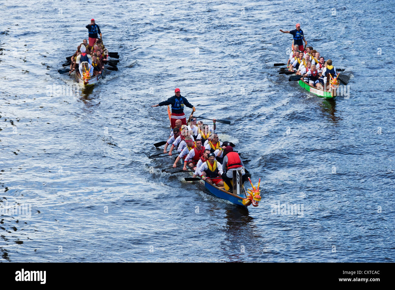 Boats crossing the finishing line at the Dragon Boat Race Racing ...