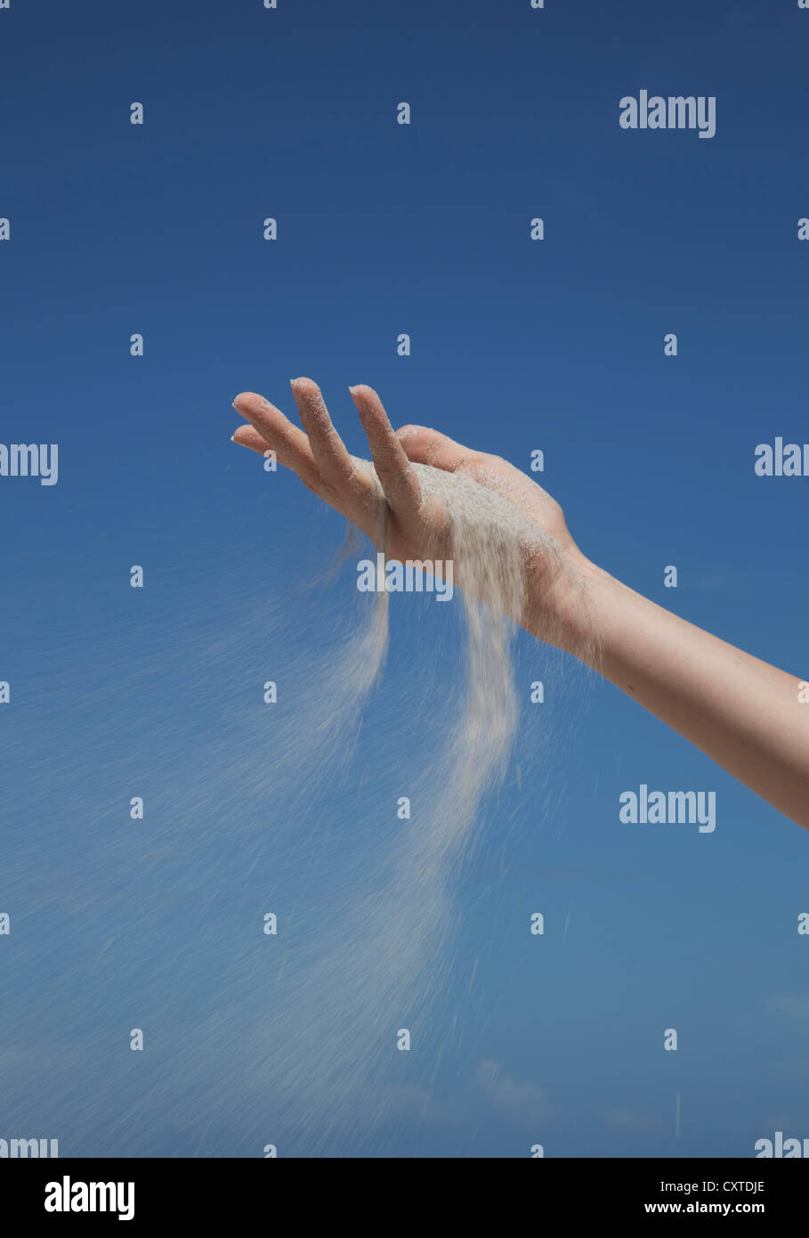 Close up of sand pouring from hand Stock Photo - Alamy