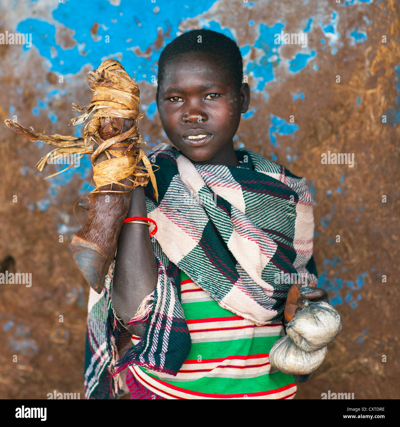 Woman From Menit Tribe Holding An Animal's Leg, Jemu, Omo Valley ...