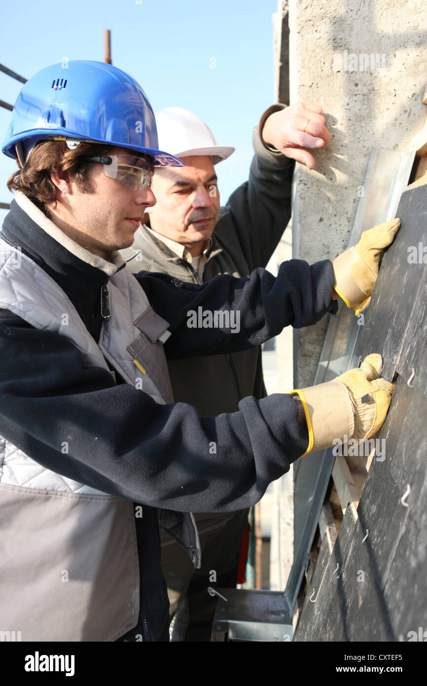 Tradesmen working together Stock Photo - Alamy