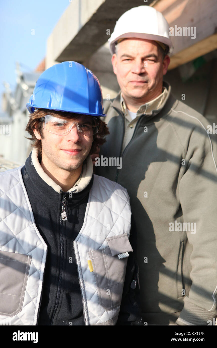 Builder and his apprentice Stock Photo - Alamy