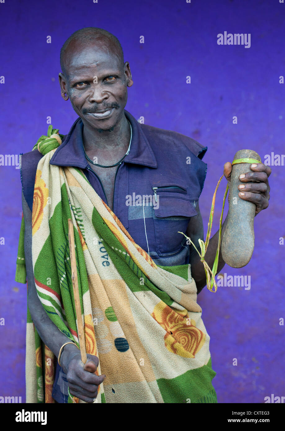 Suri Tribe Man Holding A Stone Used To Change The Shape Of Cows Horns ...