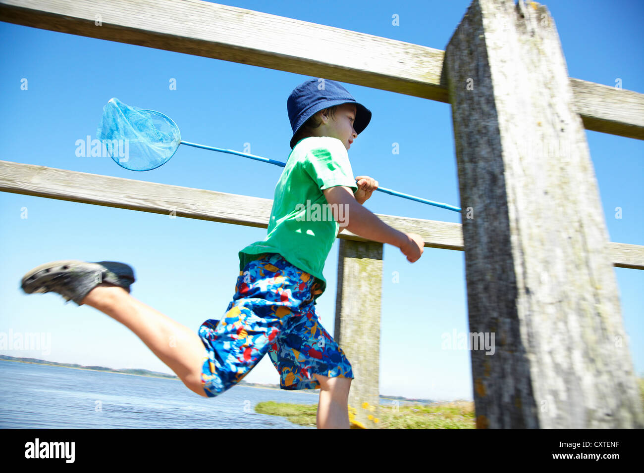 Mixed race children running blue sky hi-res stock photography and ...