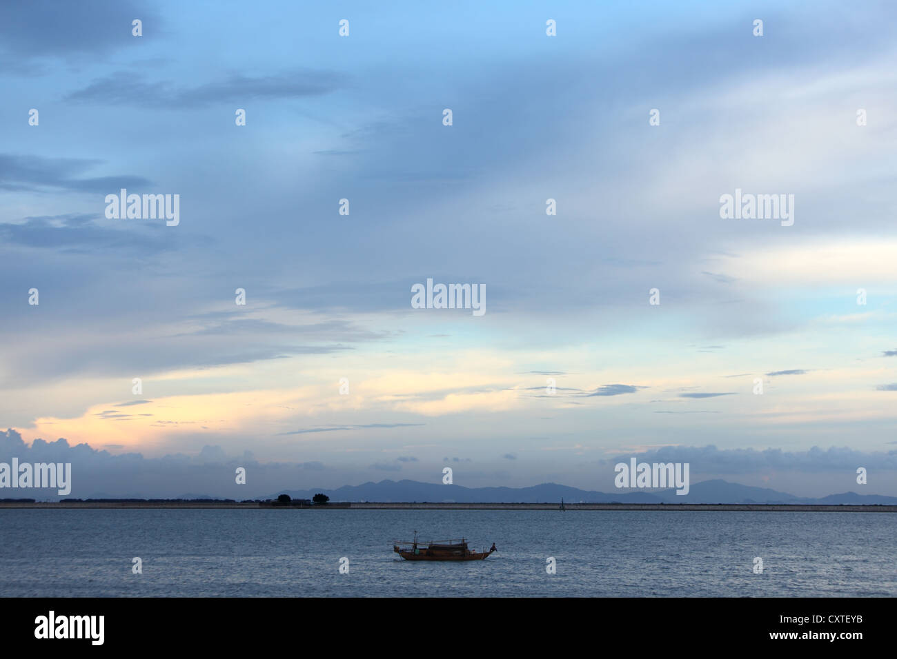 Little ship on the sea, sky, cloud, mountain Stock Photo - Alamy
