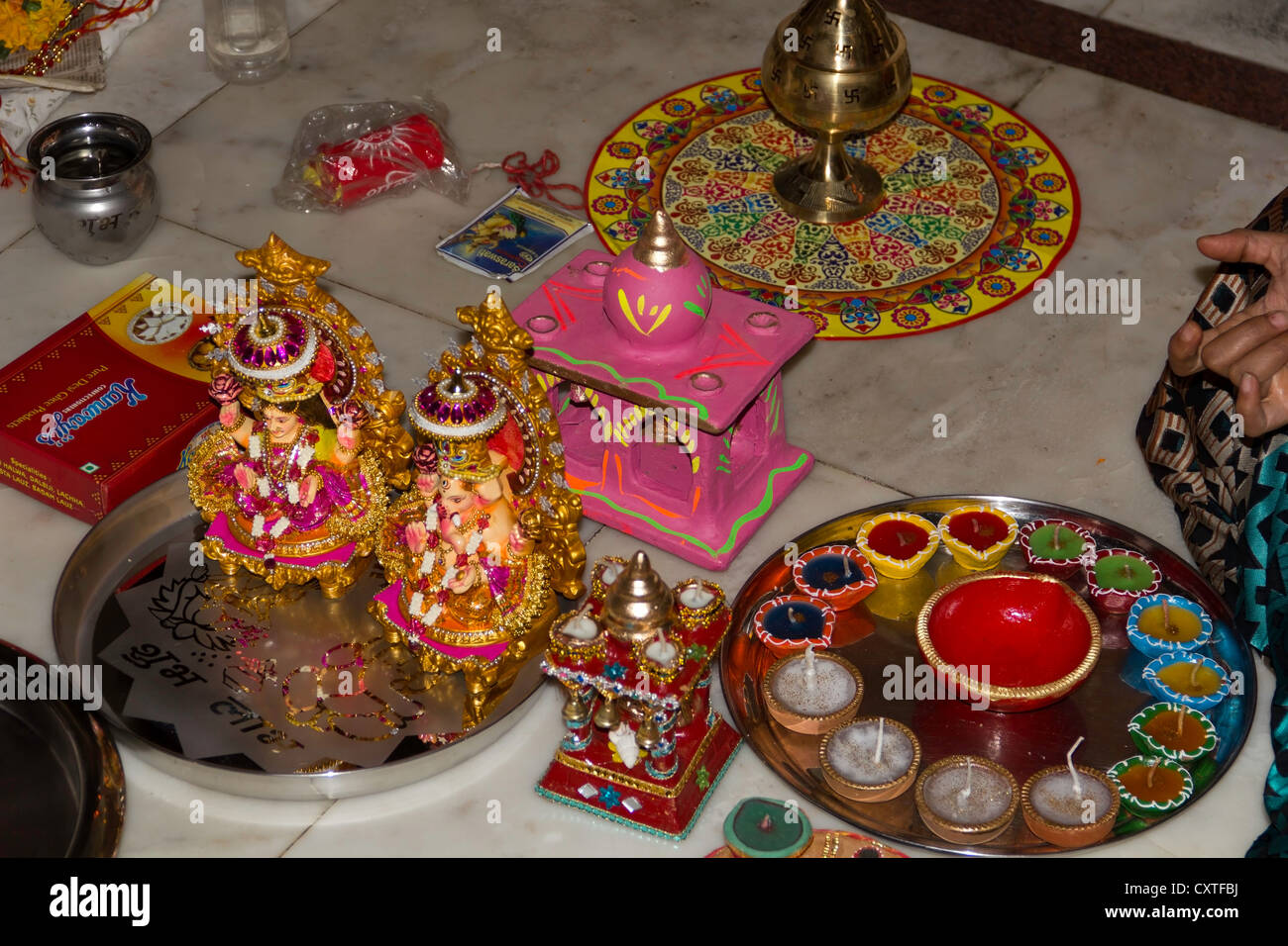Statues of gods and oil lamps as part of prayers at Diwali. These are ...