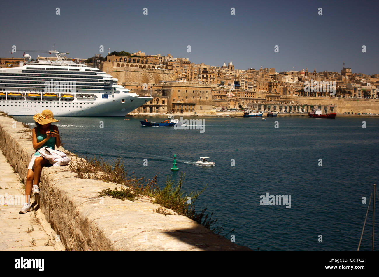 A young female tourist uses her cell phone in Senglea, Malta, June 10 ...