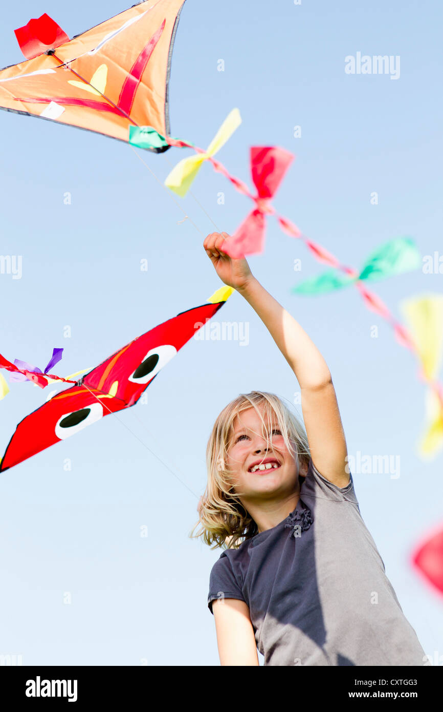 Girl playing with kite outdoors Stock Photo - Alamy