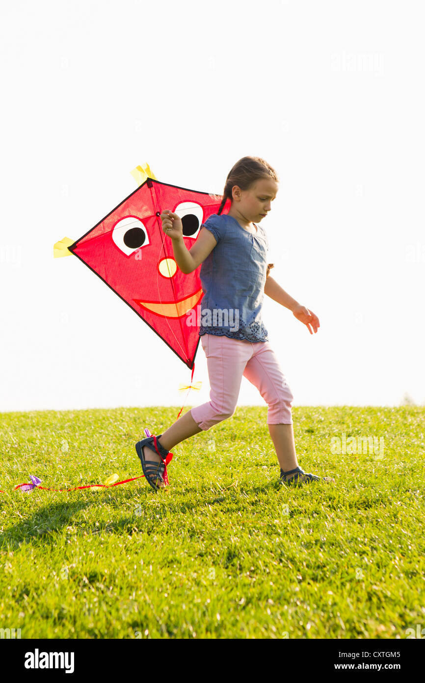Girl playing with kite outdoors Stock Photo - Alamy