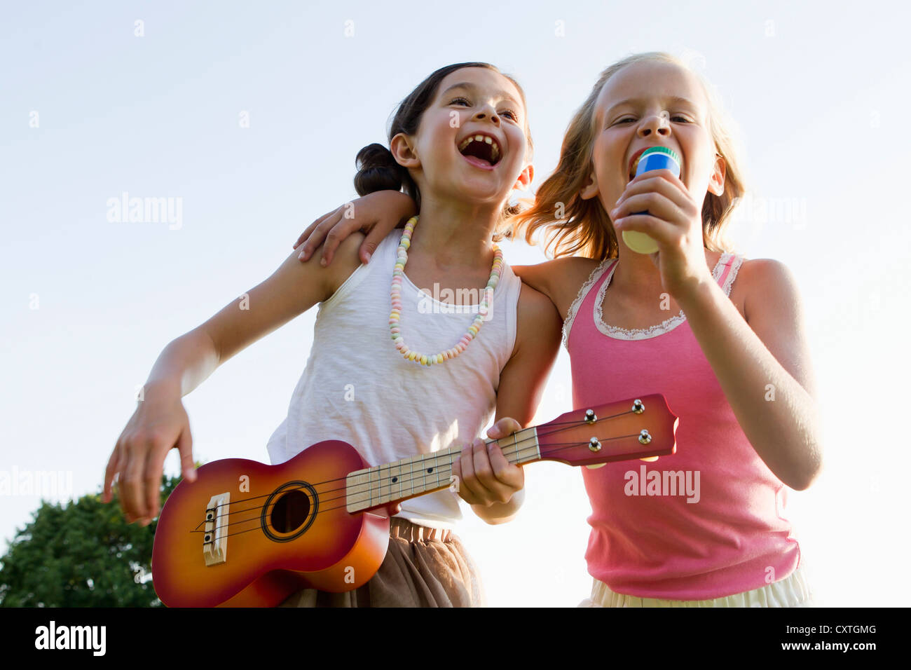 Girls singing together outdoors Stock Photo - Alamy