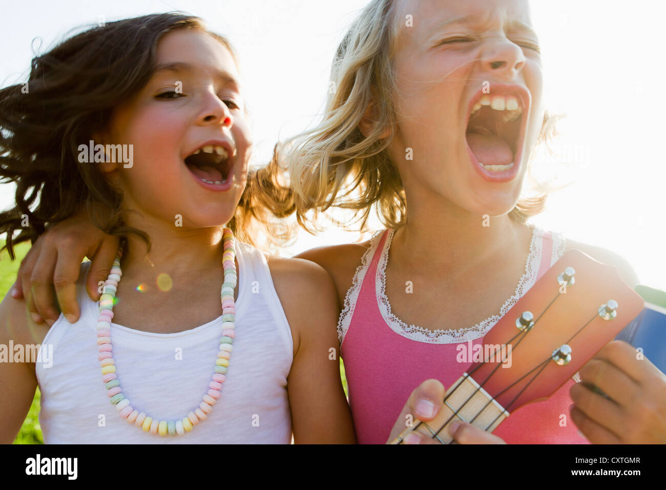 Girls singing together outdoors Stock Photo - Alamy