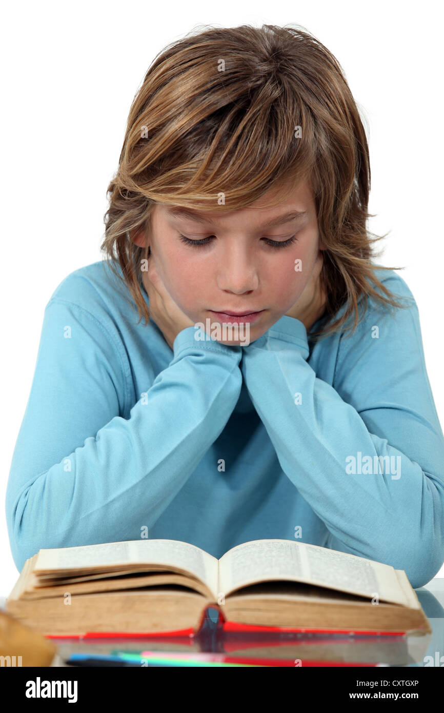 Boy reading a book Stock Photo - Alamy