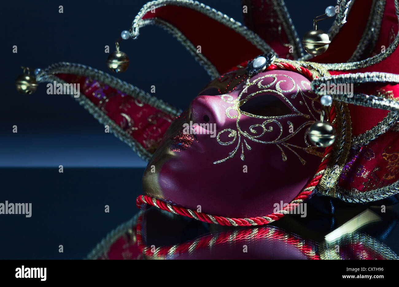 The Venetian mask with bells on a mirror table Stock Photo - Alamy