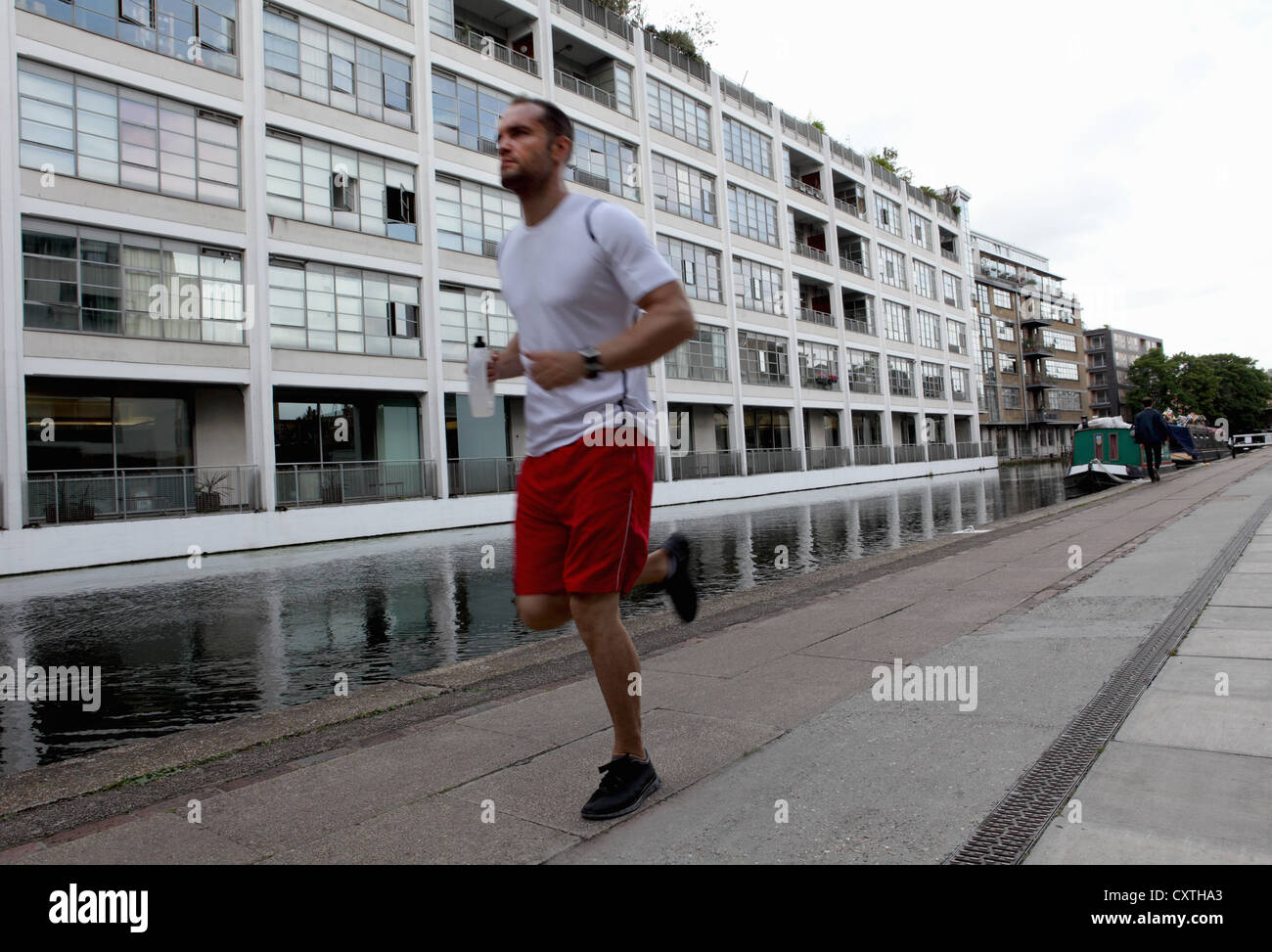 Man running on city street Stock Photo - Alamy