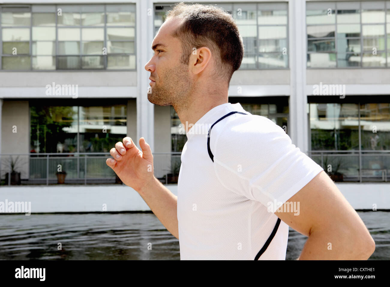 Man running on city street Stock Photo - Alamy