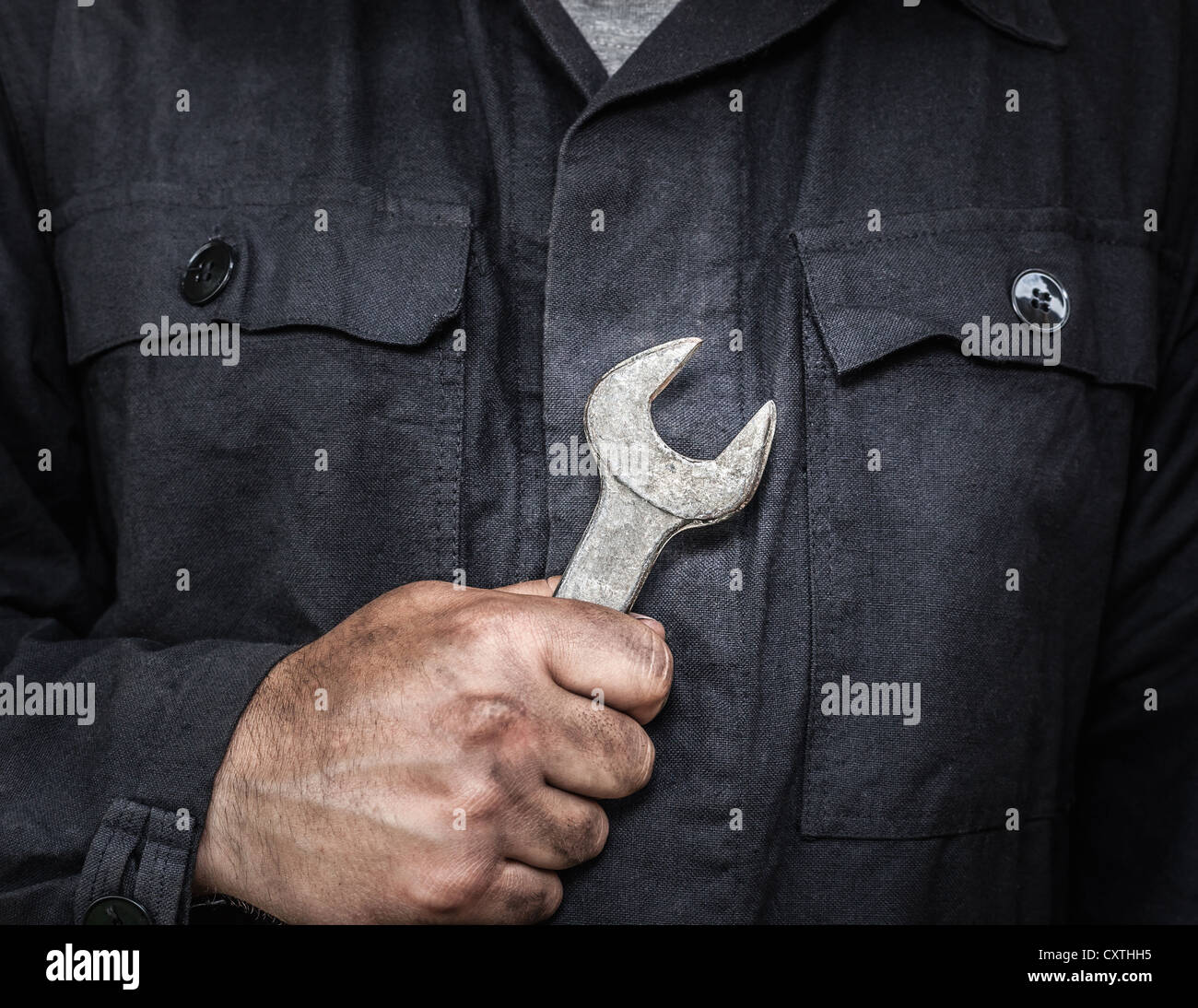 Close up of worker holding wrench Stock Photo - Alamy