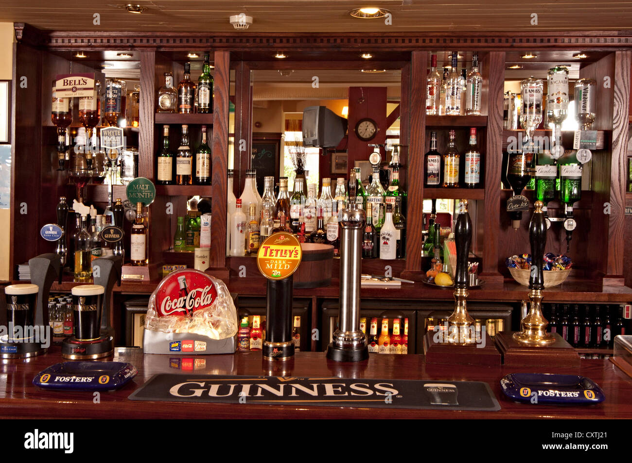 Coca cola tetleys Beer pumps at a bar in a pub in the uk Stock Photo ...