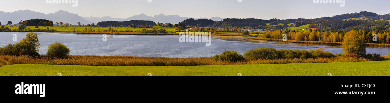 wide panorama view over a lake to alps mountains in bavaria, germany ...