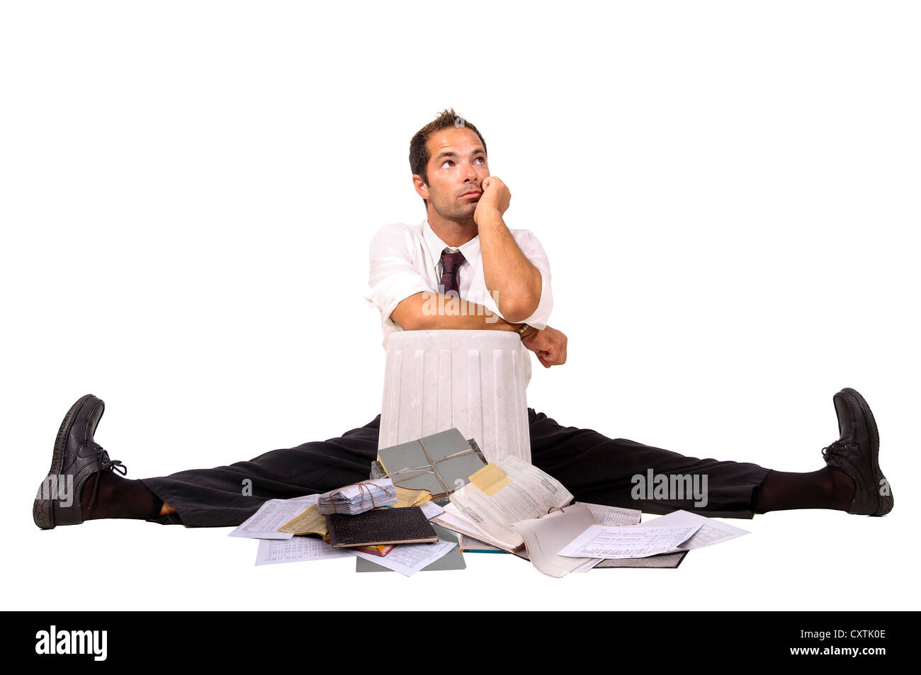 Businessman doing splits with office trash Stock Photo - Alamy