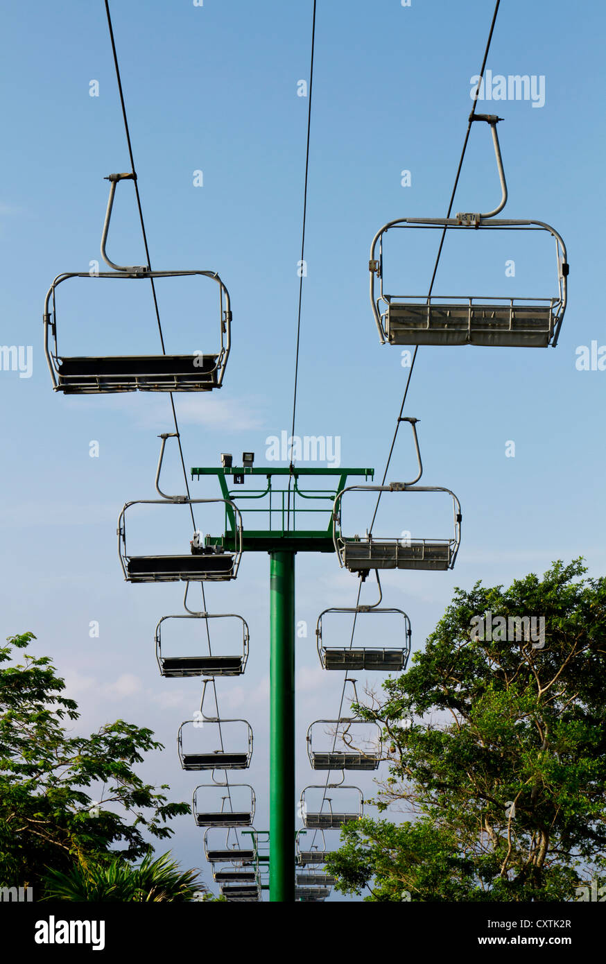Fun chair lift sky ride with blue sky and foliage in background Stock ...