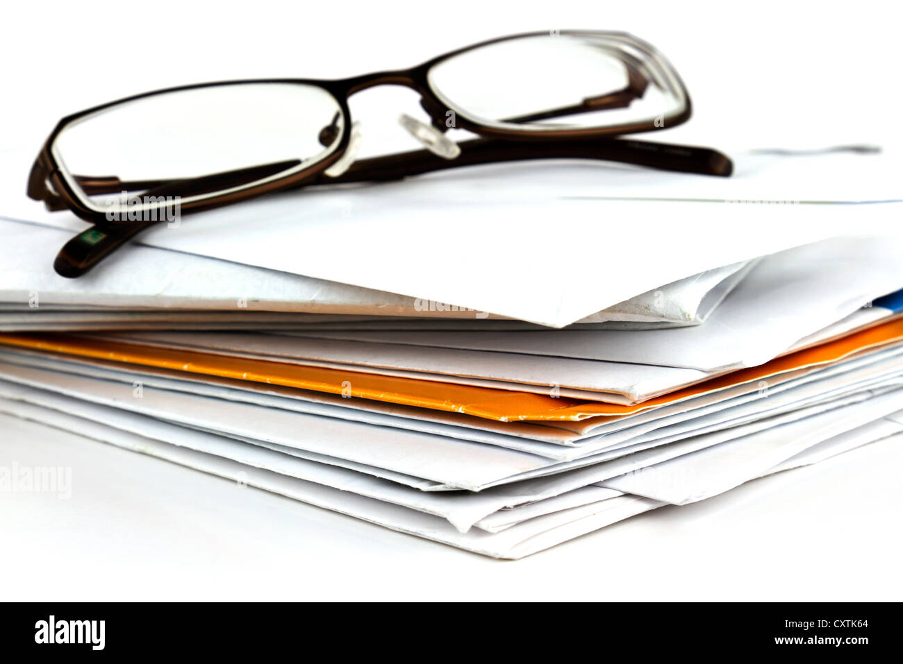 Stack of postal mail with pair of eyeglasses on white background Stock ...