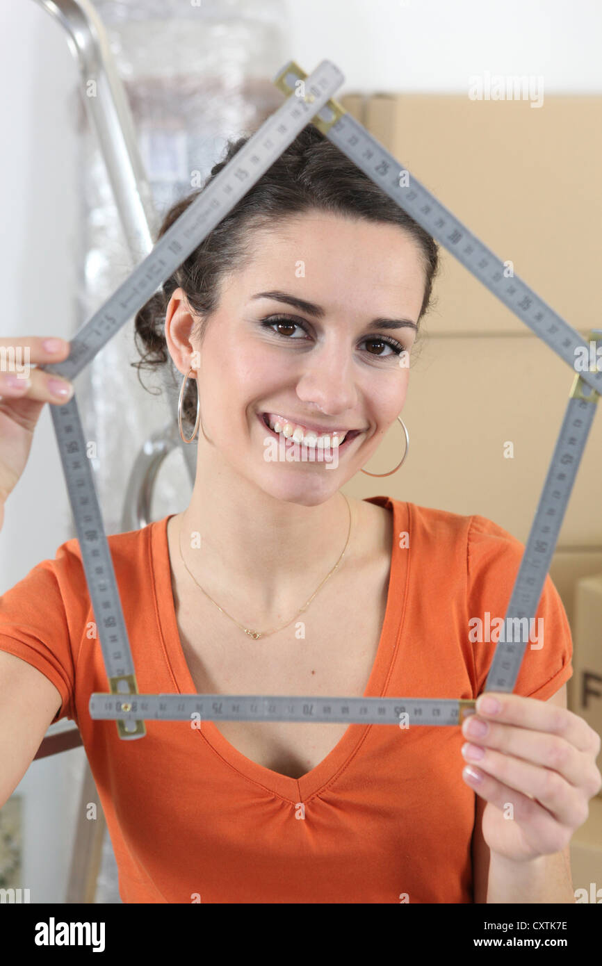 Woman holding measuring device Stock Photo - Alamy