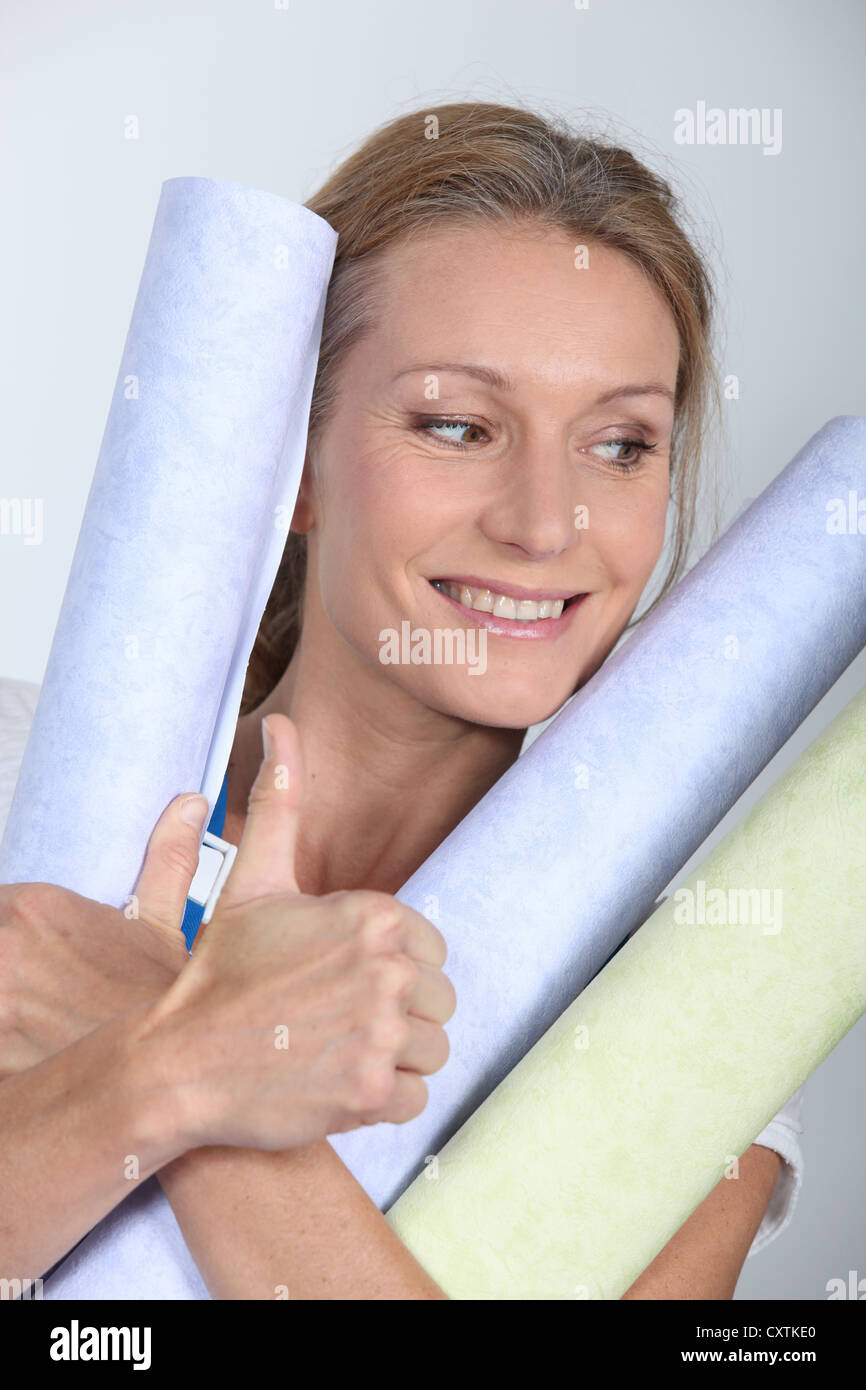 Woman holding rolls of wallpaper Stock Photo - Alamy