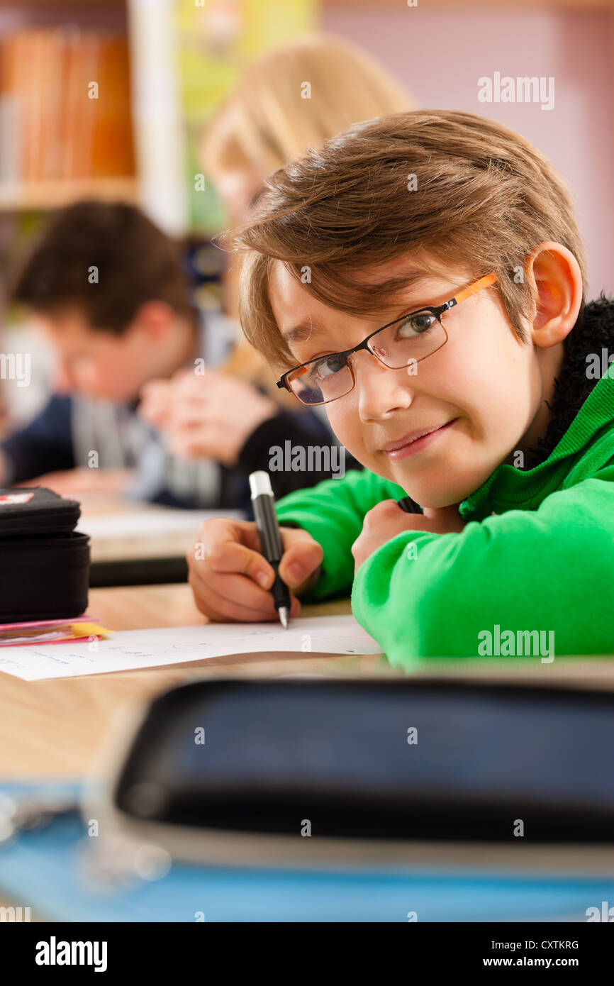 Education - Pupils at primary or elementary school doing their homework ...