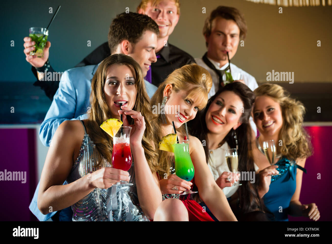 Young people in club or bar drinking cocktails and having fun Stock ...