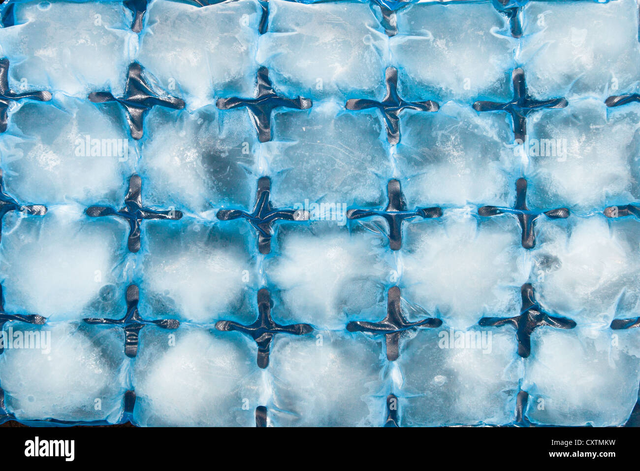 Ice cubes in a polythene mould as a background Stock Photo - Alamy