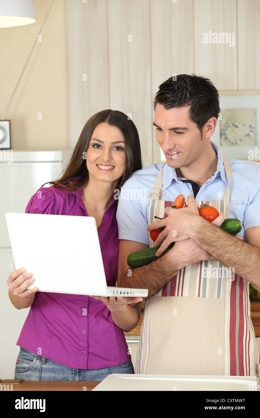 Couple looking-up recipe Stock Photo - Alamy