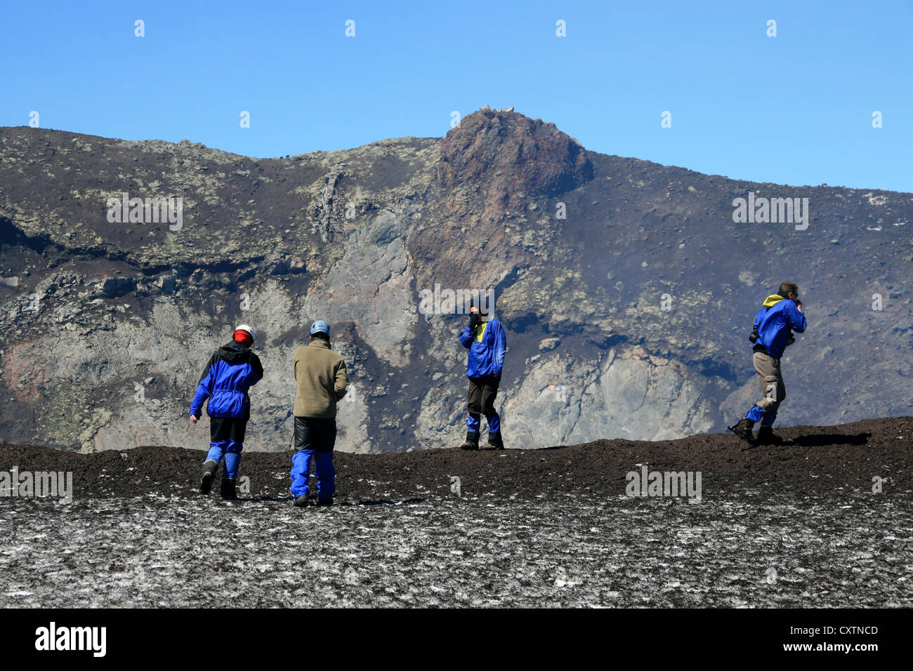 Climbers at the top of the Villarica volcano shielding their faces from ...