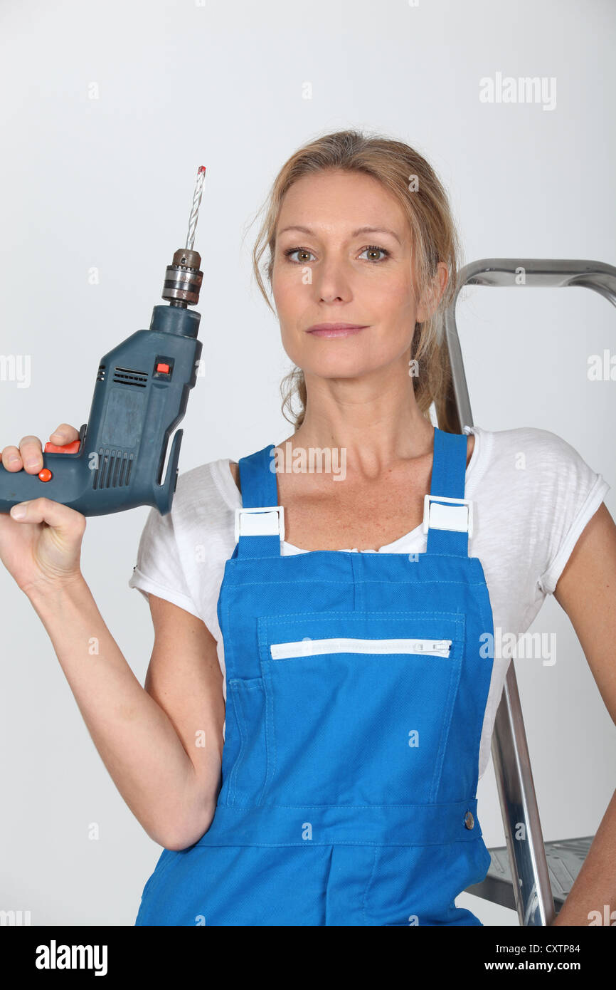Woman posing with a drill Stock Photo - Alamy