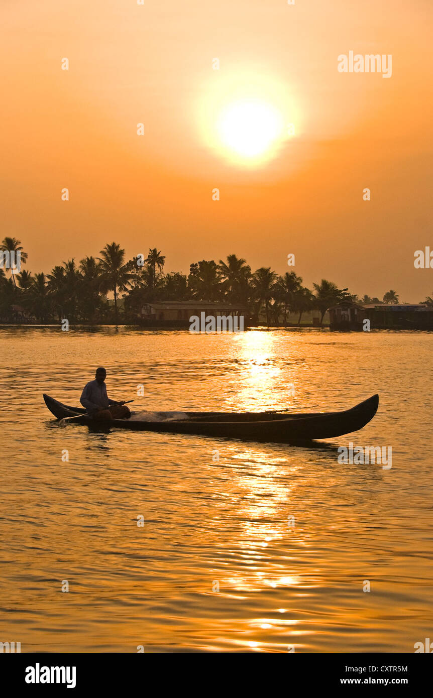 Vertical view of a glorious sunset in the backwaters of Kerala with a ...