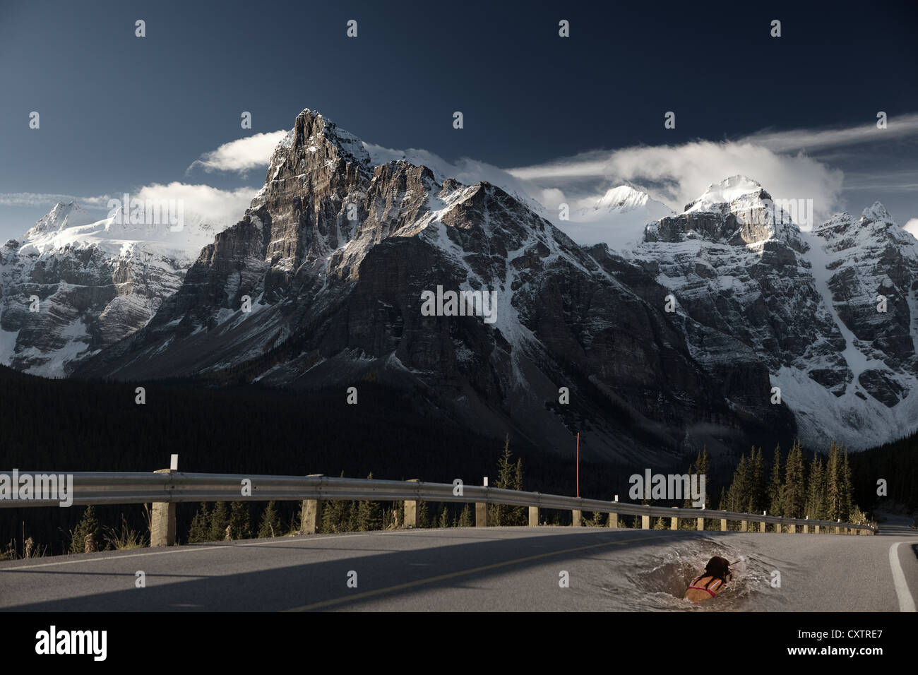 Woman swimming in the road - photo surrealism Stock Photo - Alamy