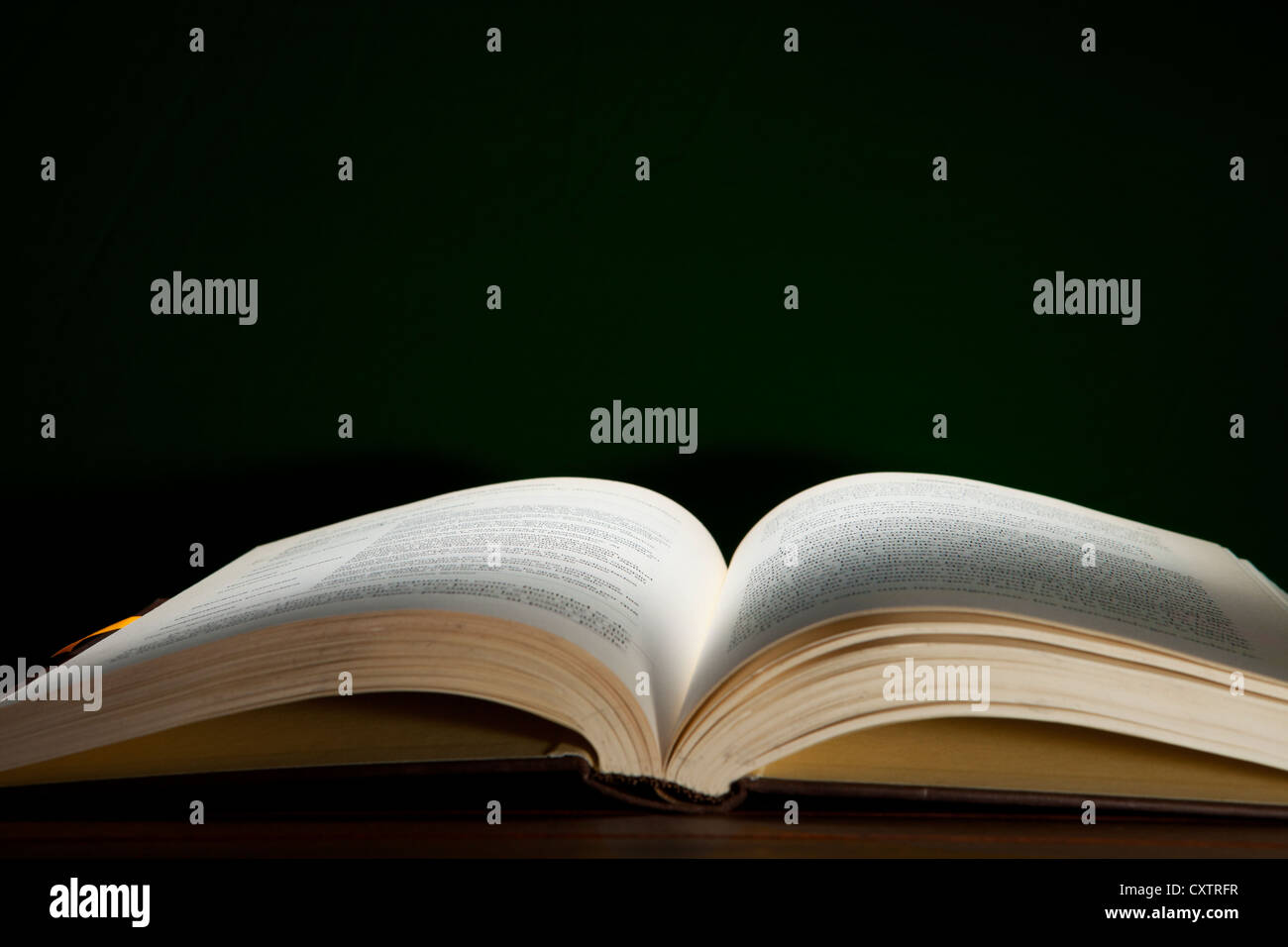 Open book in the shadows Stock Photo - Alamy
