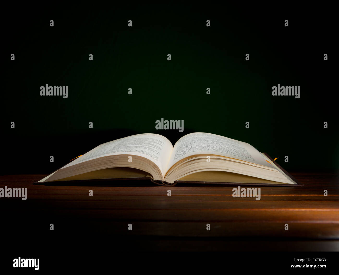 Open book in the shadows Stock Photo - Alamy
