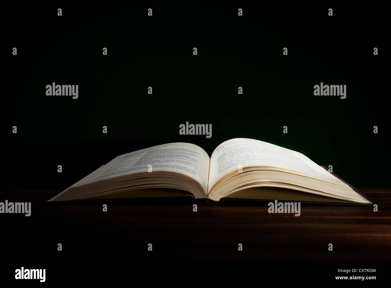 Open book in the shadows Stock Photo - Alamy