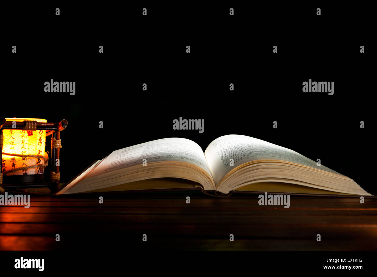 Open book in the shadows Stock Photo - Alamy