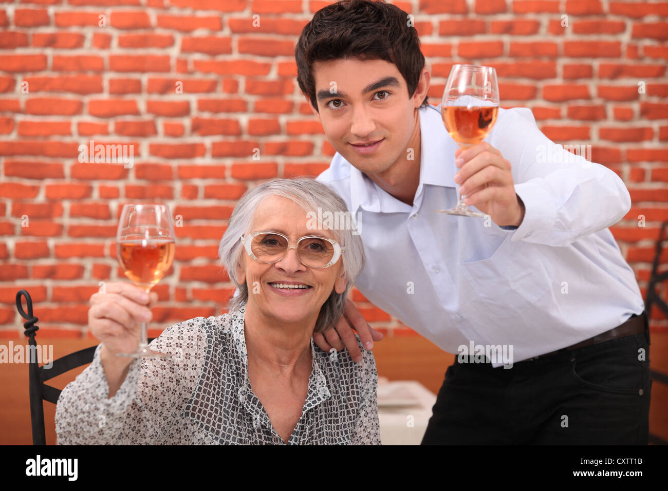 senior lady and young man making a toast Stock Photo - Alamy