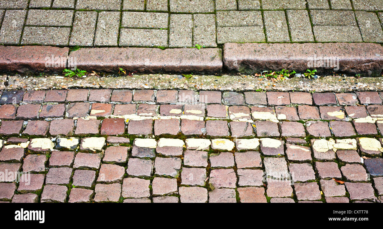 An old cobbled road and pavement in a UK town Stock Photo - Alamy