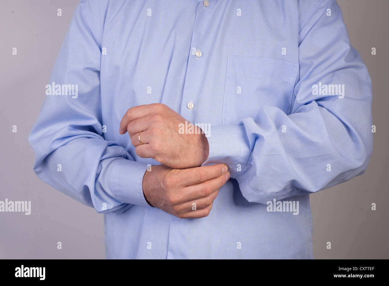 man buttoning his shirt Stock Photo - Alamy