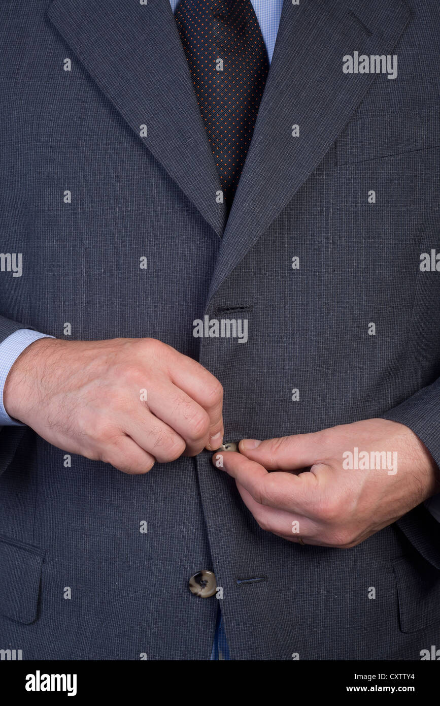 man buttoning his jacket Stock Photo - Alamy