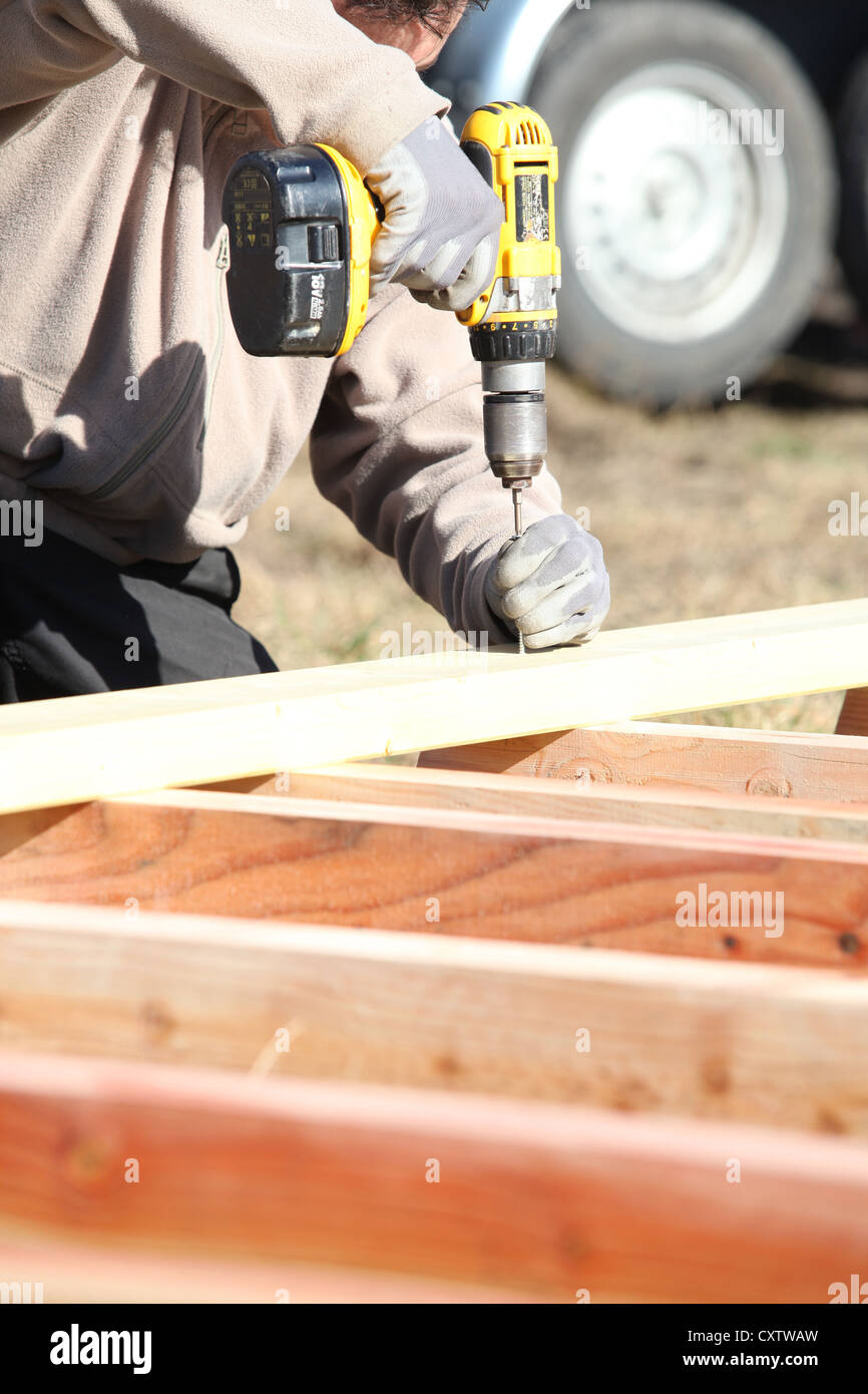 Builder using a cordless drill Stock Photo - Alamy